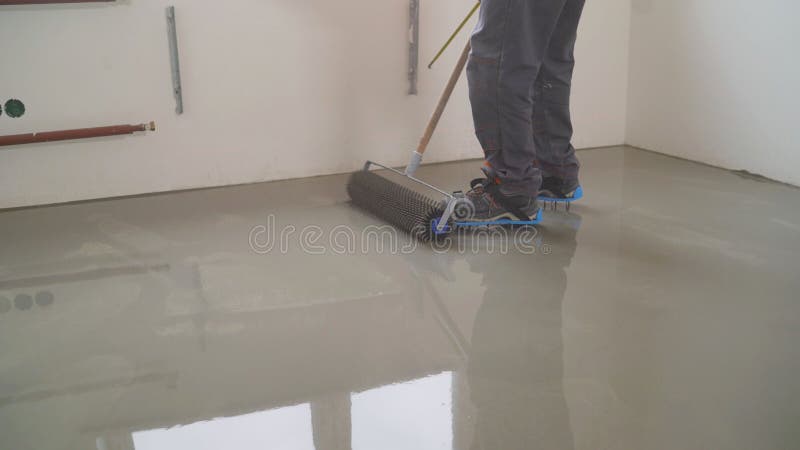 Construction Worker Leveling Wet Concrete on a Floor Stock Photo ...