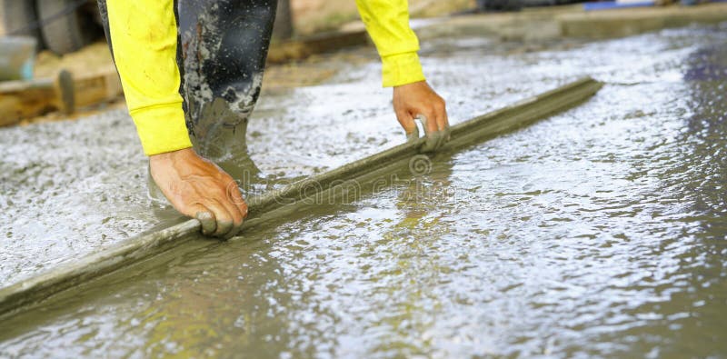 Construction Worker Leveling Wet Concrete Floor with a Trowel at ...