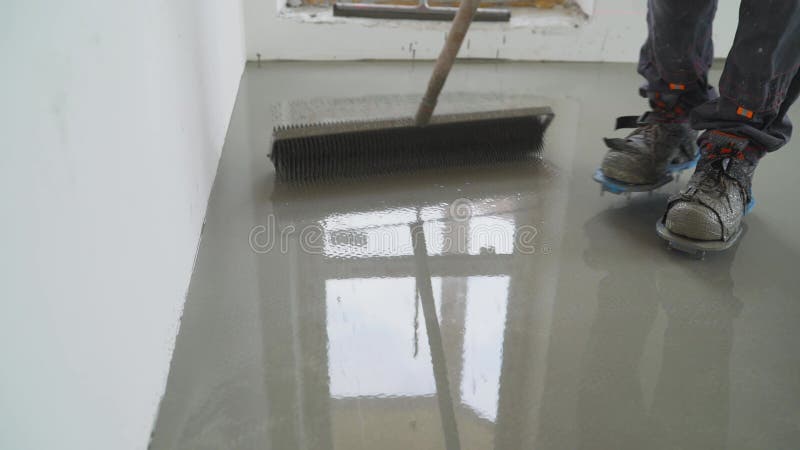 Construction Worker Leveling Concrete Surface with Needle Roller Stock ...
