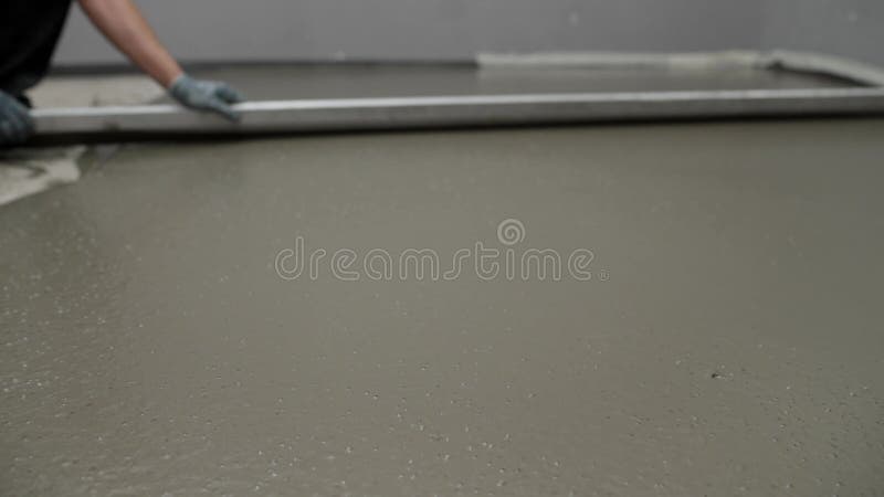 Construction Worker Leveling Concrete Floor Using Trowel. Construction ...