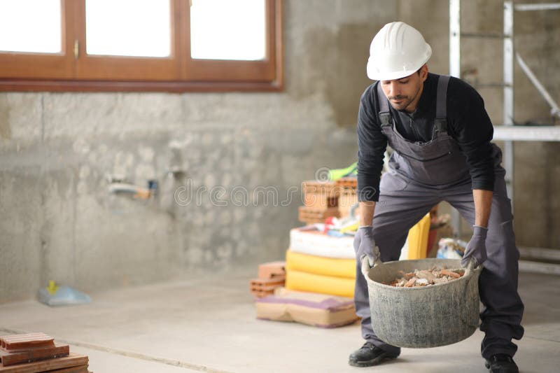 Construction Worker Lifting a Heavy Carrycot Stock Image - Image of ...