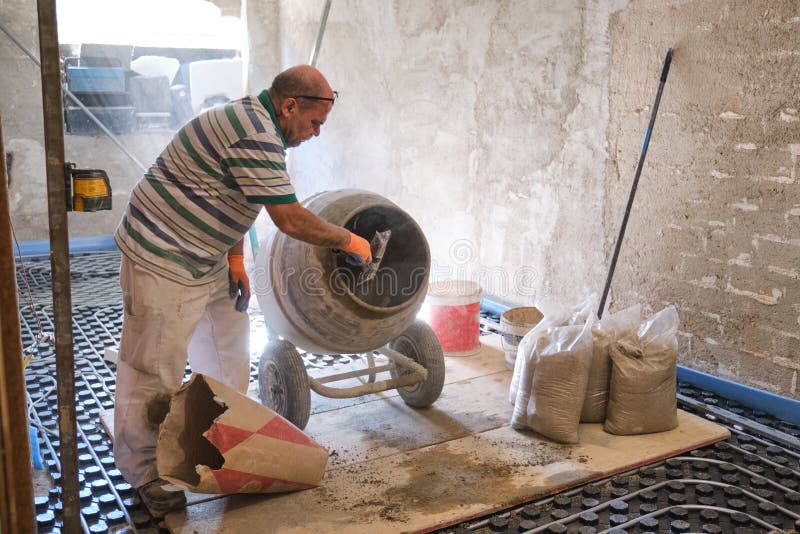 Construction Worker Loading Lime Mortar into the Concrete Mixer. Stock ...