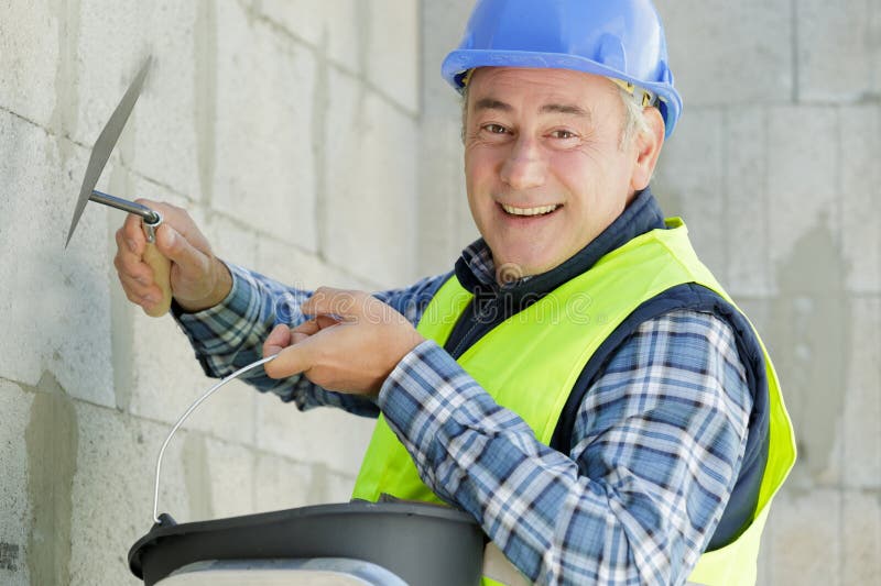Construction Worker with Long Trowel Plastering Wall Stock Image ...