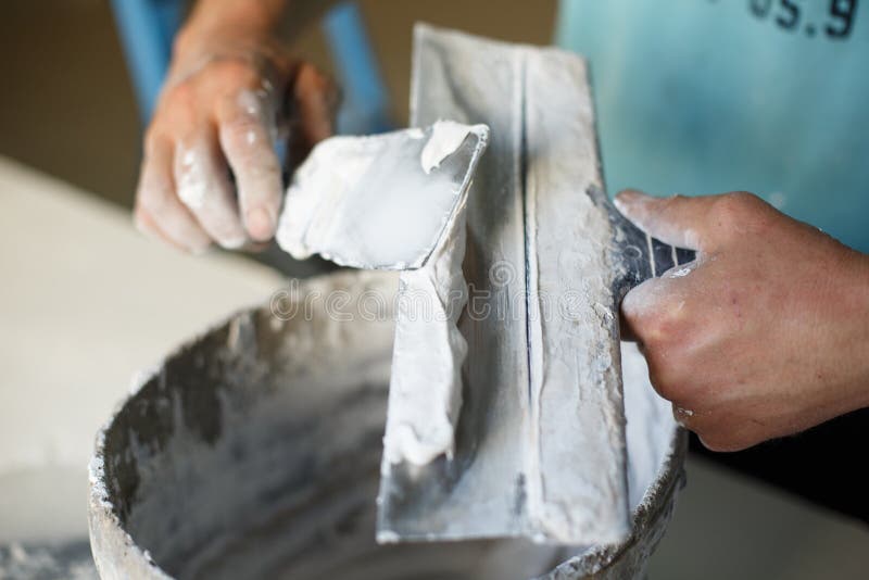 Construction Worker with Long Trowel Plastering a Wall. Close-up of ...