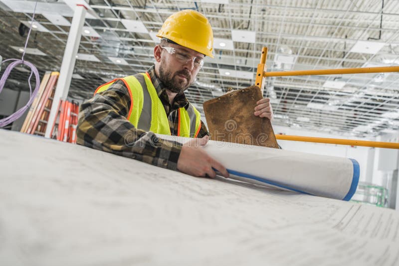 Construction Worker Looking Inside Building Blueprints Stock Image ...
