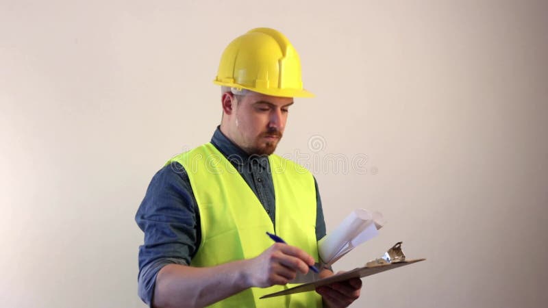 Construction Worker Looking at Papers Then Looking Afar and Nodding ...