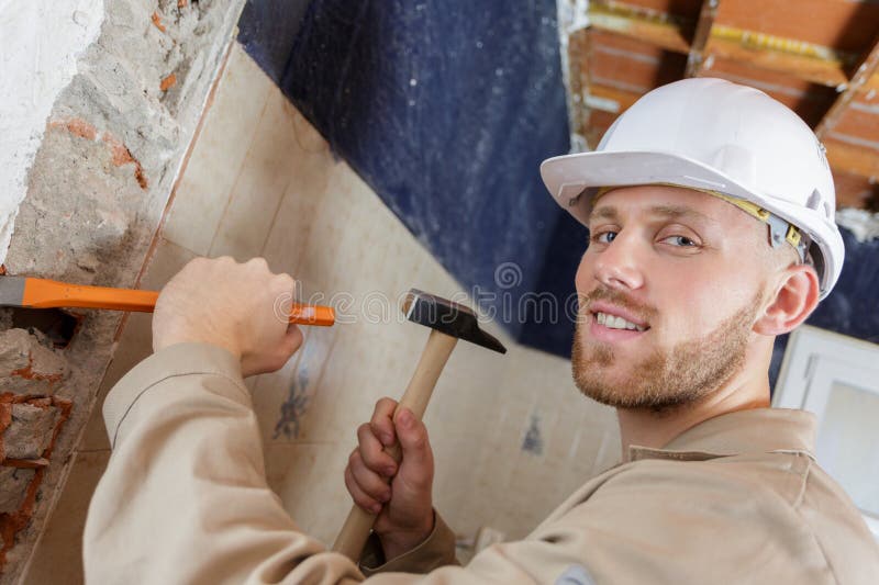 Construction Worker Making Hole in Wall with Hammer Stock Image - Image ...