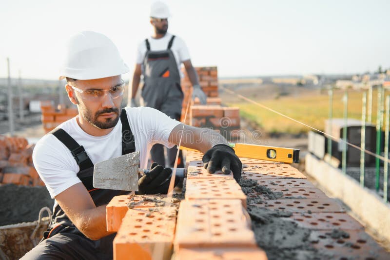 Construction Worker Man in Work Clothes and a Construction Helmet ...