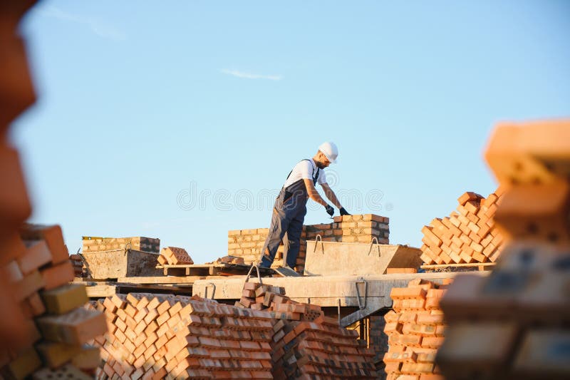 Construction Worker Man in Work Clothes and a Construction Helmet ...