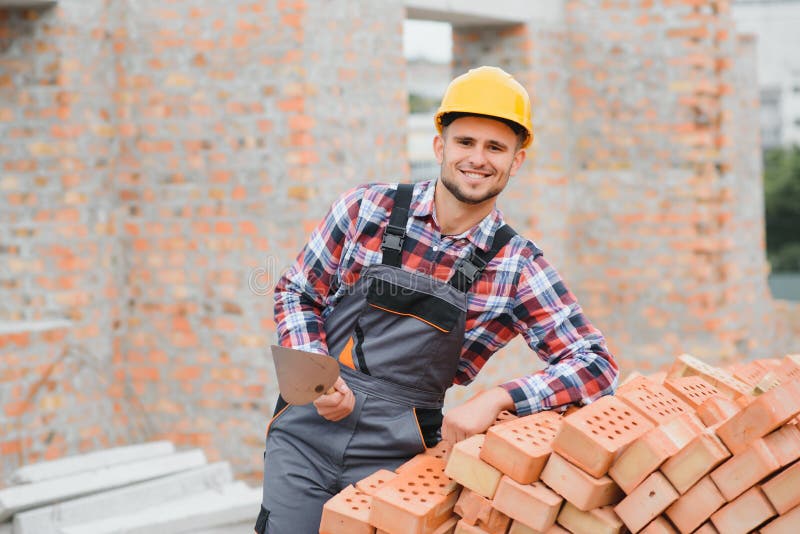Construction Worker Man in Work Clothes and a Construction Helmet ...