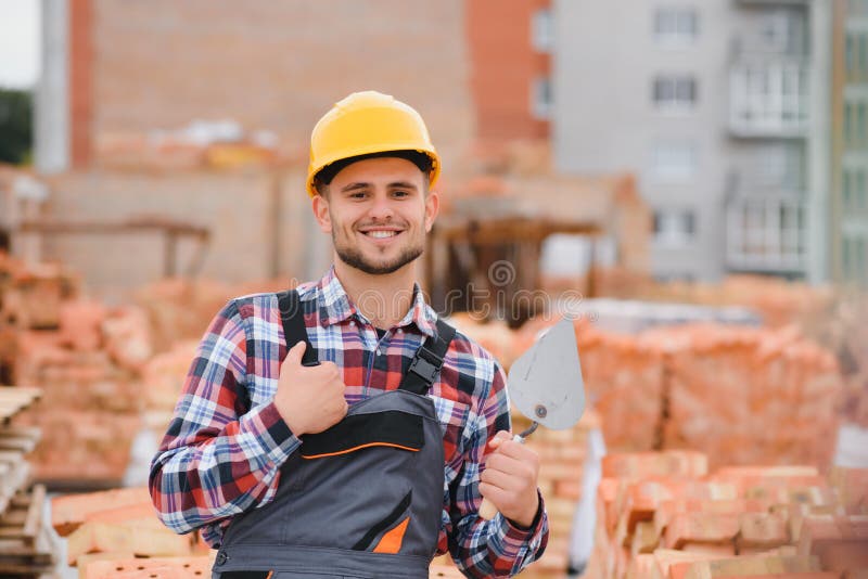 Construction Worker Man in Work Clothes and a Construction Helmet ...