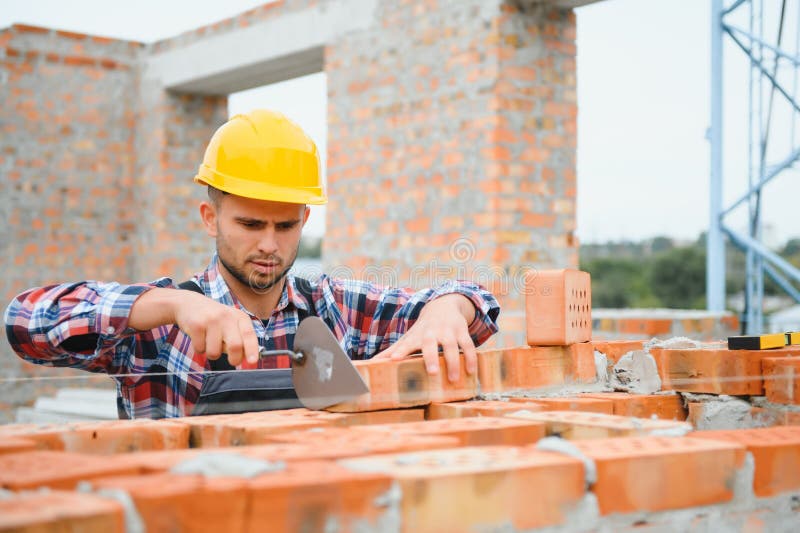 Construction Worker Man in Work Clothes and a Construction Helmet ...