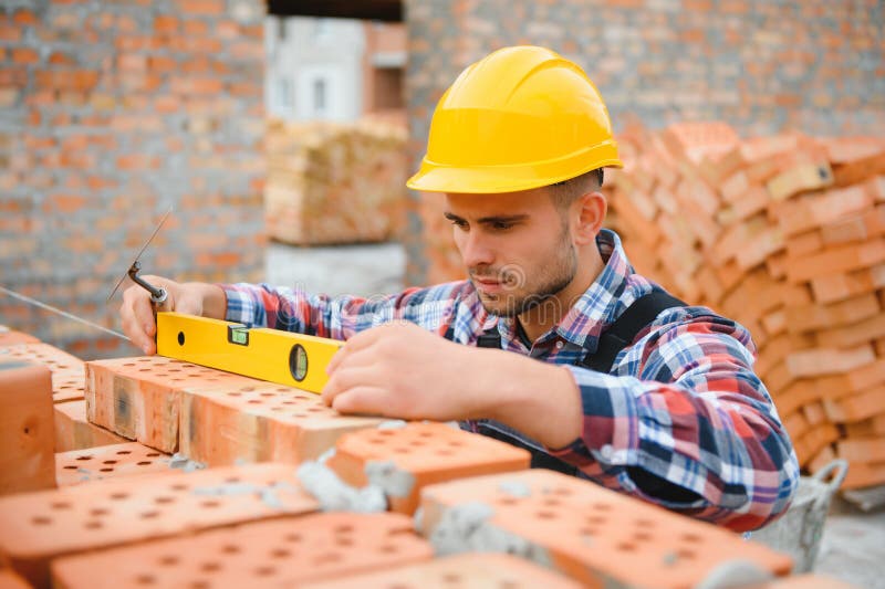 Construction Worker Man in Work Clothes and a Construction Helmet ...