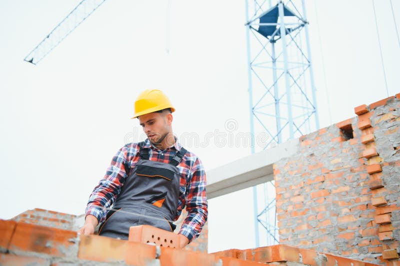 Construction Worker Man in Work Clothes and a Construction Helmet ...