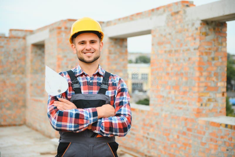 Construction Worker Man in Work Clothes and a Construction Helmet ...