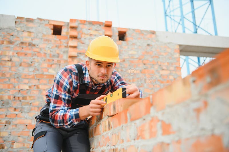 Construction Worker Man in Work Clothes and a Construction Helmet ...
