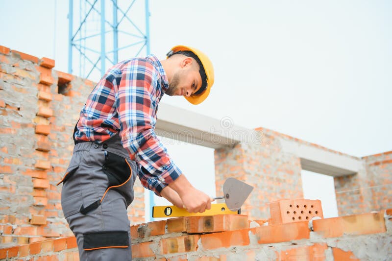 Construction Worker Man in Work Clothes and a Construction Helmet ...