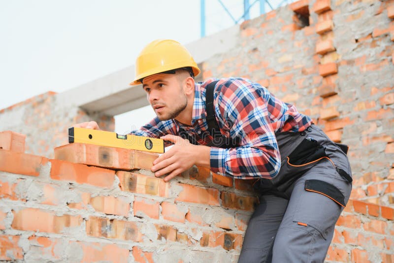 Construction Worker Man in Work Clothes and a Construction Helmet ...