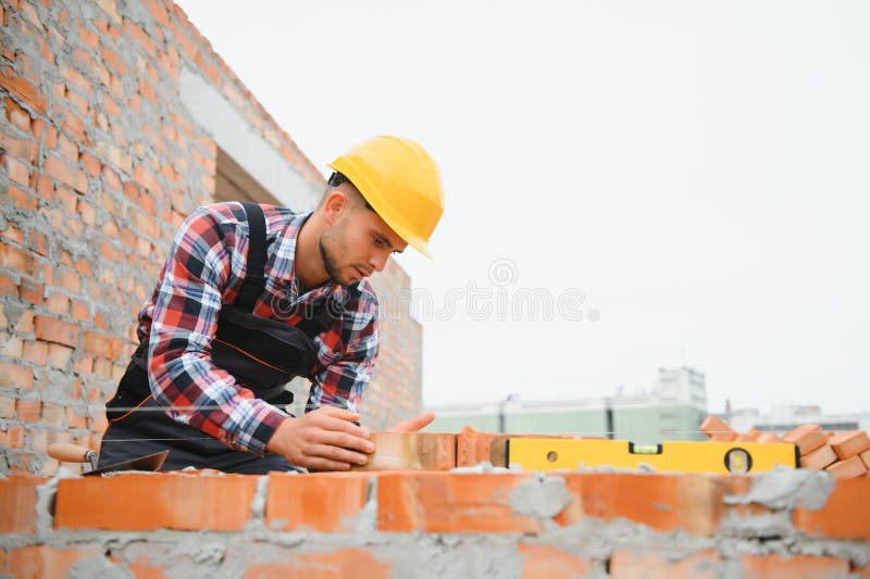 Construction Worker Man in Work Clothes and a Construction Helmet ...