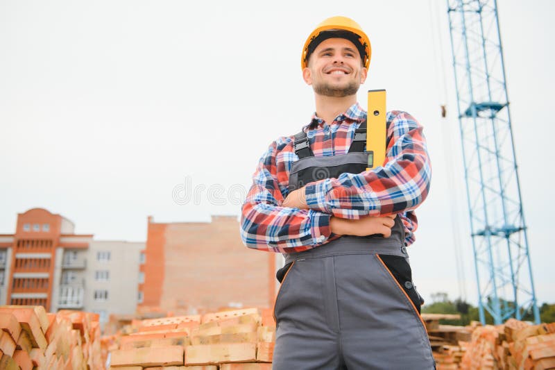 Construction Worker Man in Work Clothes and a Construction Helmet ...