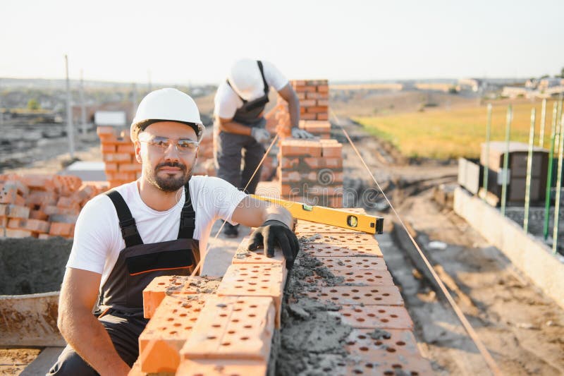 Construction Worker Man in Work Clothes and a Construction Helmet ...