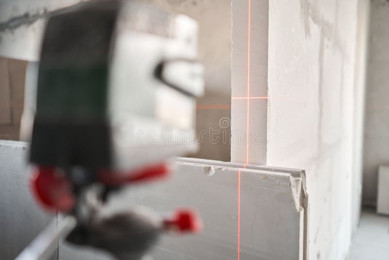 The Construction Worker Measures Horizon Level with a Laser Level ...