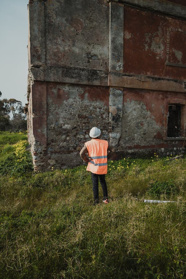 Construction Worker Measuring and Testing an Old Wall Outdoor Stock ...