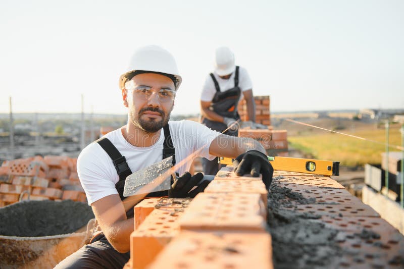 Construction Worker Man in Work Clothes and a Construction Helmet ...