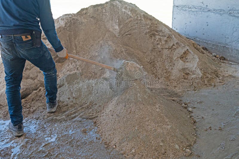 A Construction Worker Mixes Sand and Cement with a Shovel Stock Image ...
