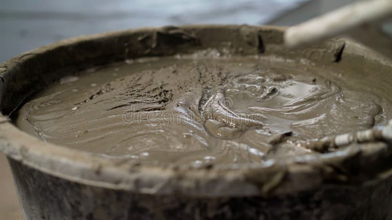 Construction Worker Mixing Cement in Bucket for Building Project Stock ...