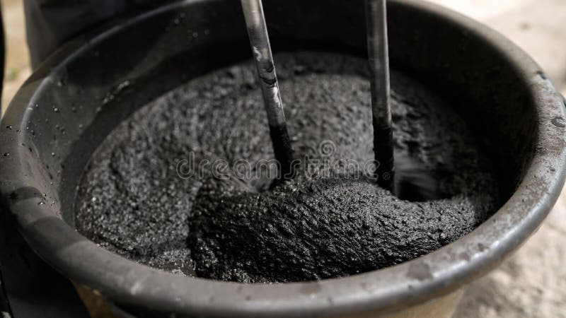 Construction Worker Mixing Cement in a Bucket Stock Photo - Image of ...