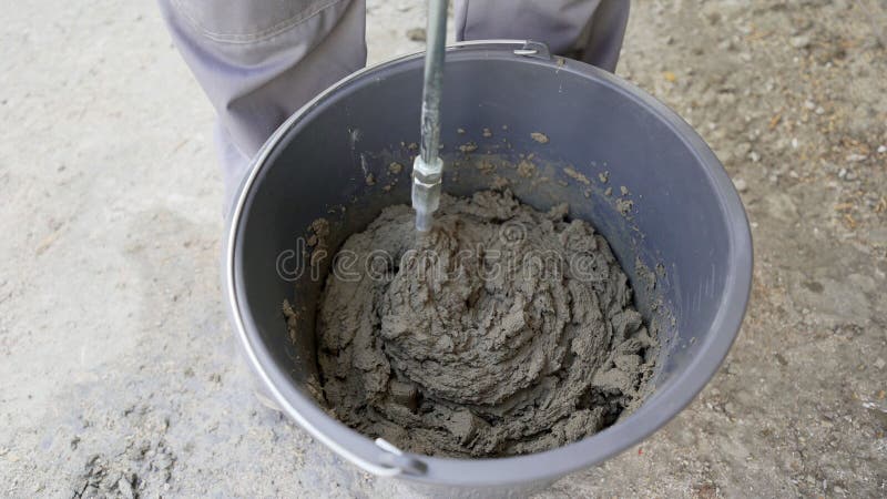 Construction Worker Mixing Cement in Bucket with Electric Mixer Stock ...