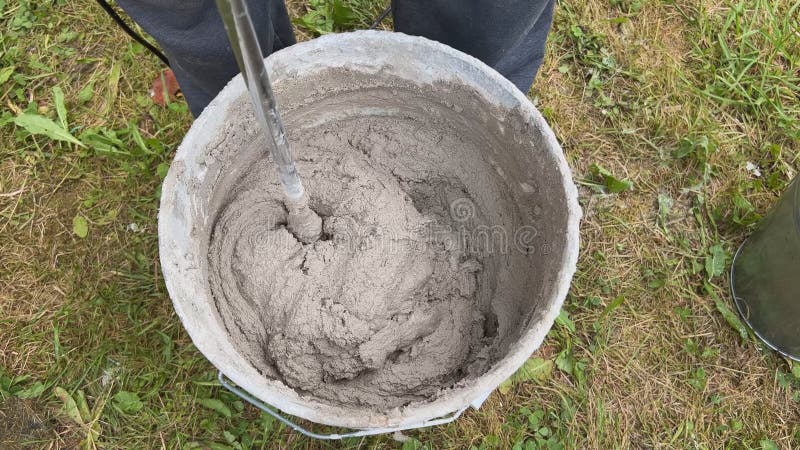 Construction Worker Mixing Cement in Bucket Using Mixing Drill Stock ...