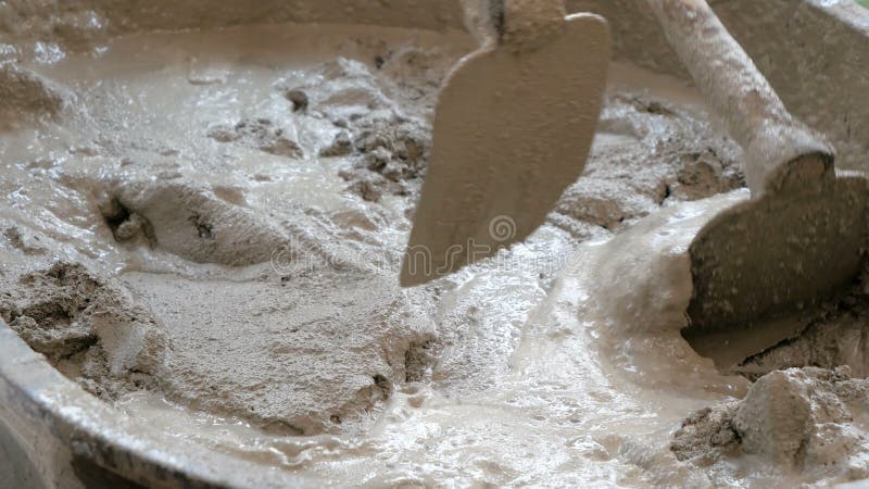 Construction Worker Mixing Concrete with Water for Building Stock ...