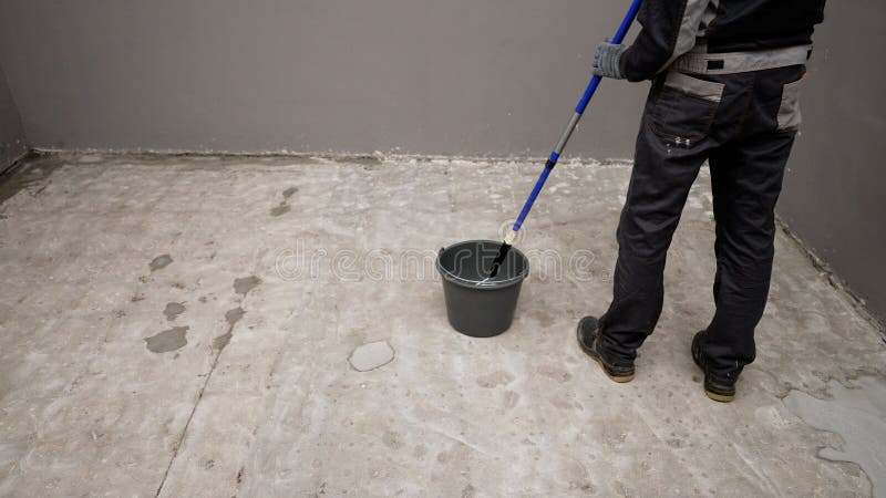 Construction Worker Cleaning Concrete Floor with Mop and Bucket Stock ...