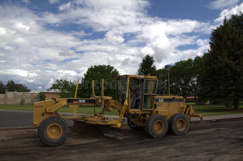 Construction Worker on Motor Grader, Bladeing Street before Paving ...
