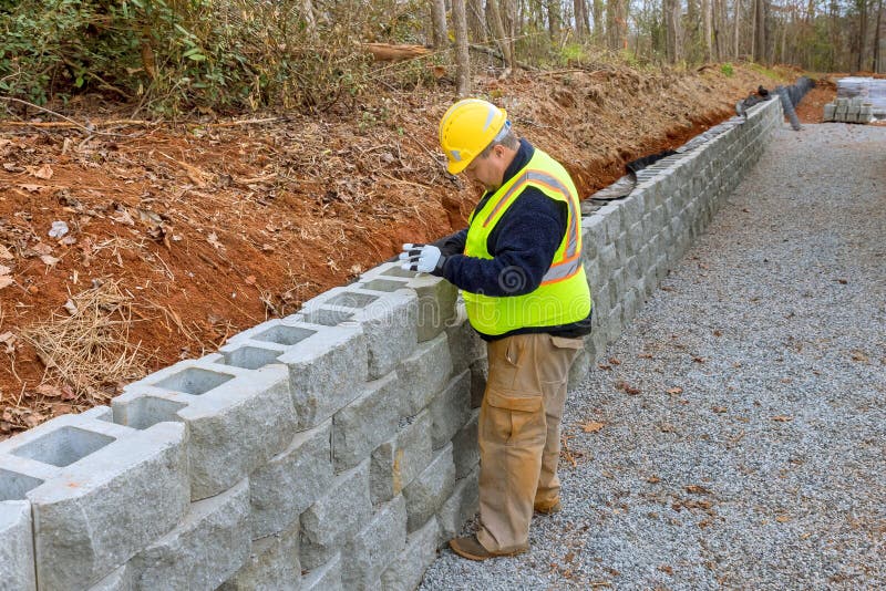 Construction Worker, am Mounting a Retaining Wall with Concrete Blocks ...