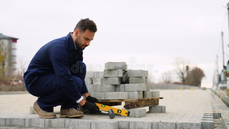 Construction Worker Laying Paving Stones on Sidewalk Stock Video ...