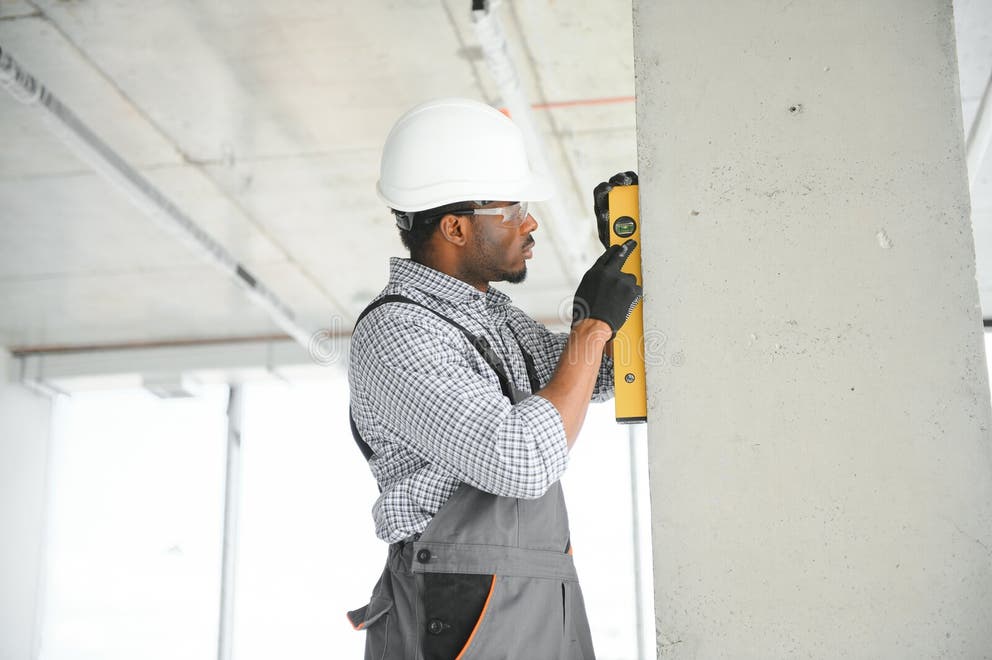 Construction Worker Observing and Surveying Wall Alignment Using Water ...