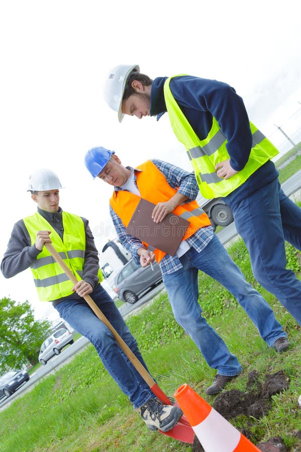 Construction Worker with One Leg on Shovel Driven into Ground Stock ...
