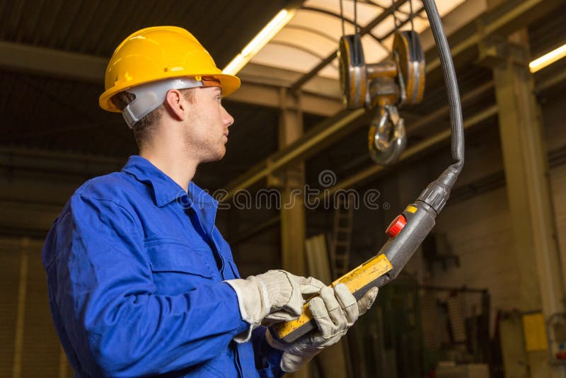 Construction Worker Operating Crane in Assembly Hall Stock Photo ...