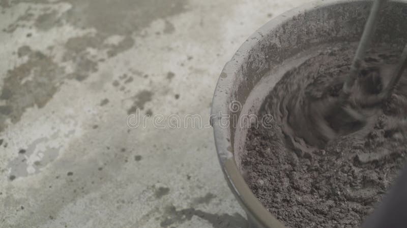 Construction Worker Mixing Cement in a Bucket Stock Video - Video of ...