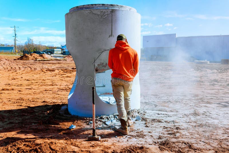 Worker Demolishes Concrete Structure at a Construction Site Under a ...