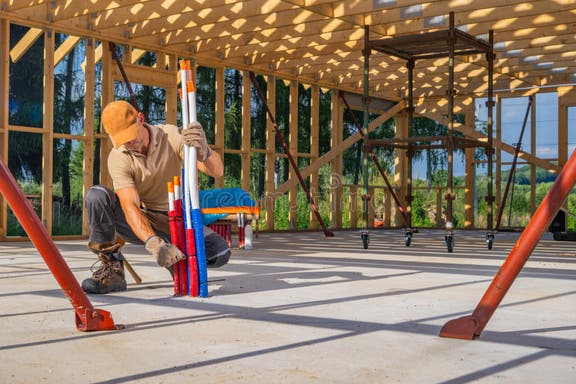 Construction Worker Organizing Support Poles in a New Building ...