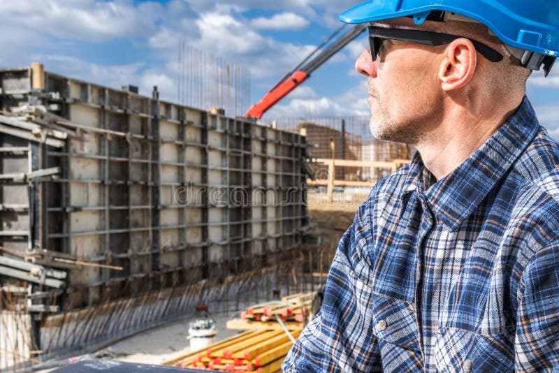 Construction Worker Overseeing the Foundation Work at a Building Site ...