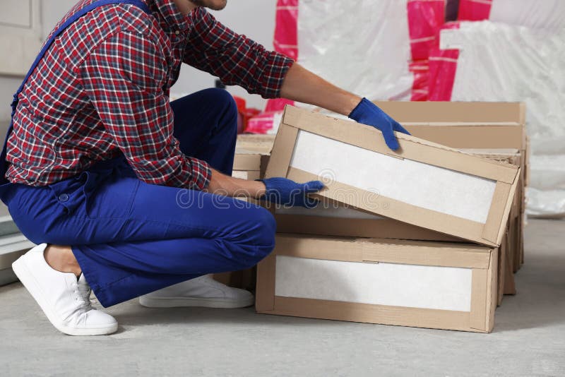 Construction Worker with Packed New Boxes in Room Prepared for ...