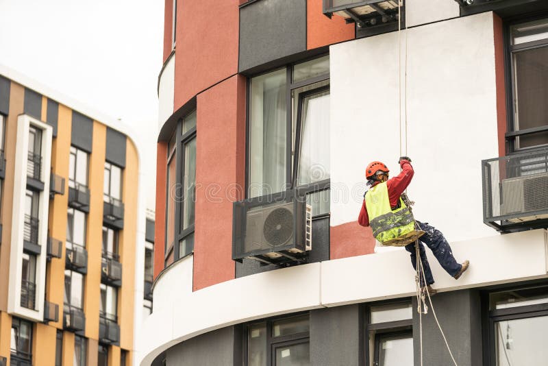 Construction Worker is Painting a Wall with a Roller Stock Photo ...