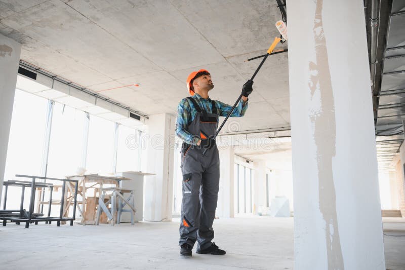 Construction Worker Painting Walls and Ceiling with Telescopic Paint ...