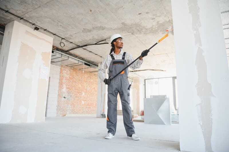 Construction Worker Painting Walls and Ceilings in Building Under ...