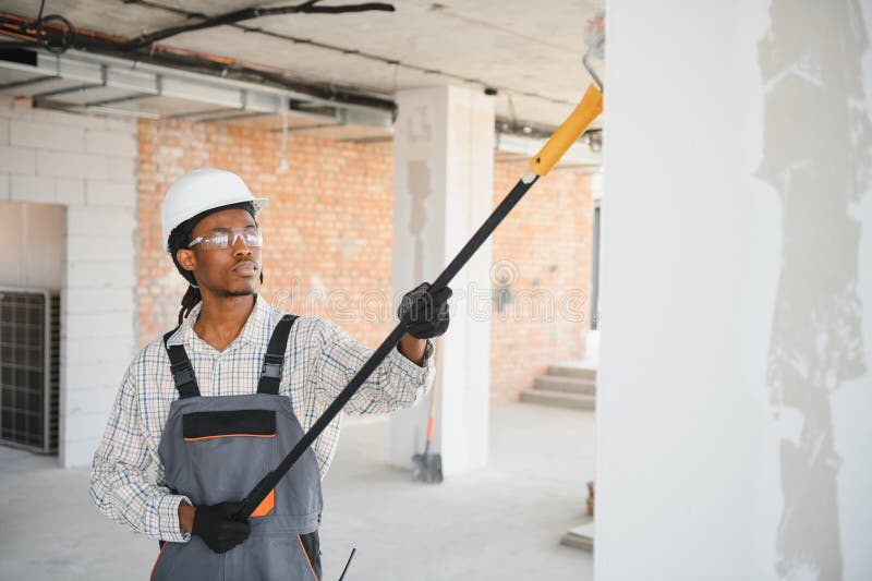 Construction Worker Painting Walls with Telescopic Paint Roller Stock ...